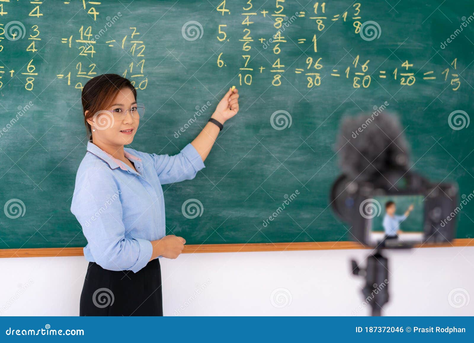 Asian Primary Teacher Tutor Explaining Math in Blackboard Giving Remote ...