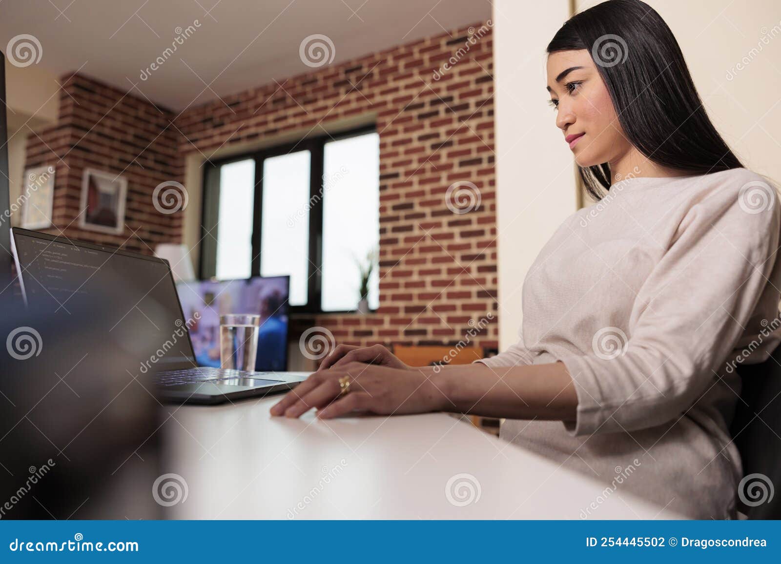 Asian Programmer Woman Pointing And Looking On Multiple Laptop Screen ... Asian Programmer Woman Pointing And Looking On Multiple Laptop Screen ...