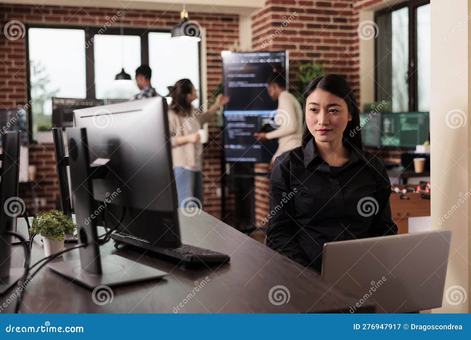 Asian Programmer Woman Pointing And Looking On Multiple Laptop Screen ... Asian Programmer Woman Pointing And Looking On Multiple Laptop Screen ...
