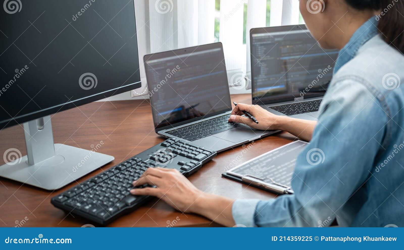 Asian Programmer Woman Pointing And Looking On Multiple Laptop Screen ... Asian Programmer Woman Pointing And Looking On Multiple Laptop Screen ...