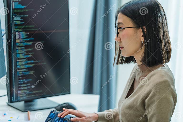 Asian Prompt Engineer Develop Coding App With Software Data Sitting In Front Of Computer Monitor