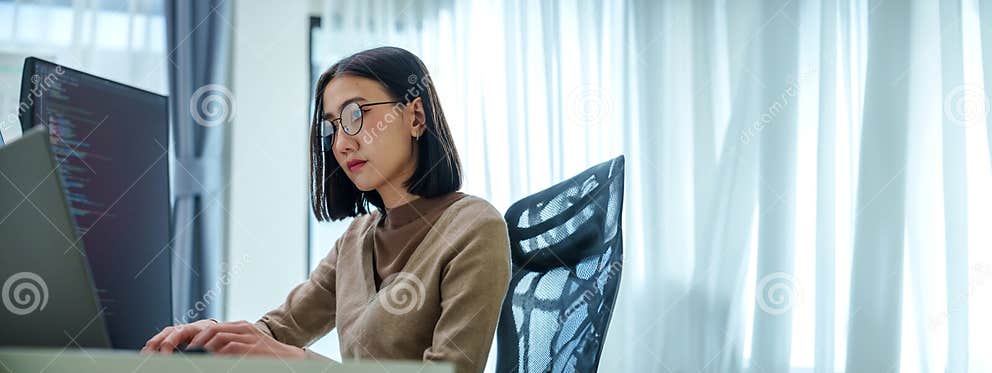 Asian Prompt Engineer Develop Coding App With Software Data Sitting In Front Of Computer Monitor