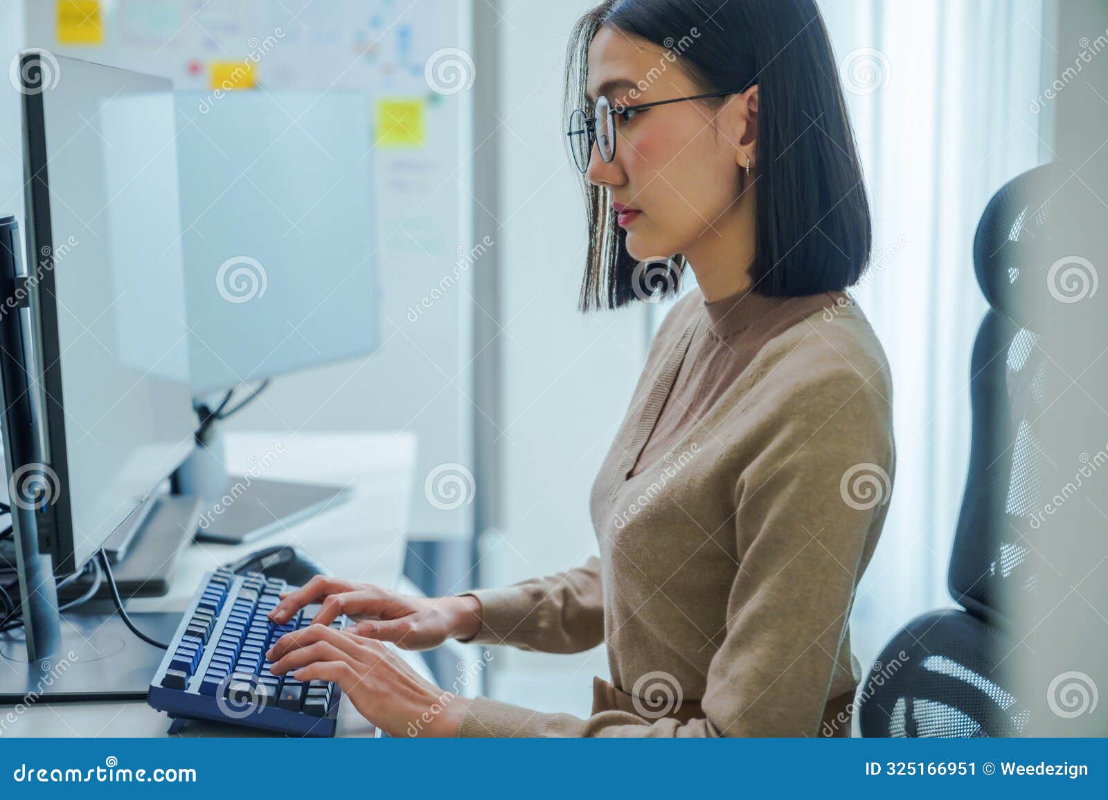 Asian Prompt Engineer Develop Coding App With Software Data Sitting In Front Of Computer Monitor