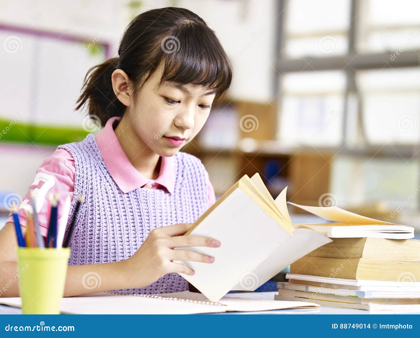 Asian Pupil Reading a Book in Classroom Stock Photo - Image of kong ...