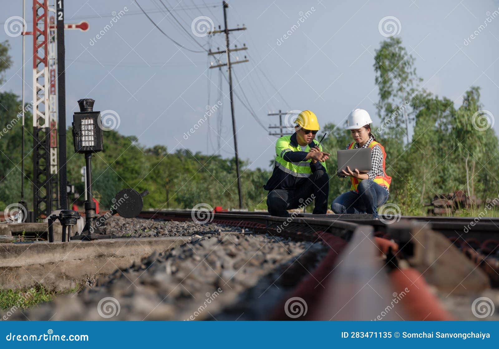 Asian Railway Engineer Inspects a Train Station Engineer Working on ...