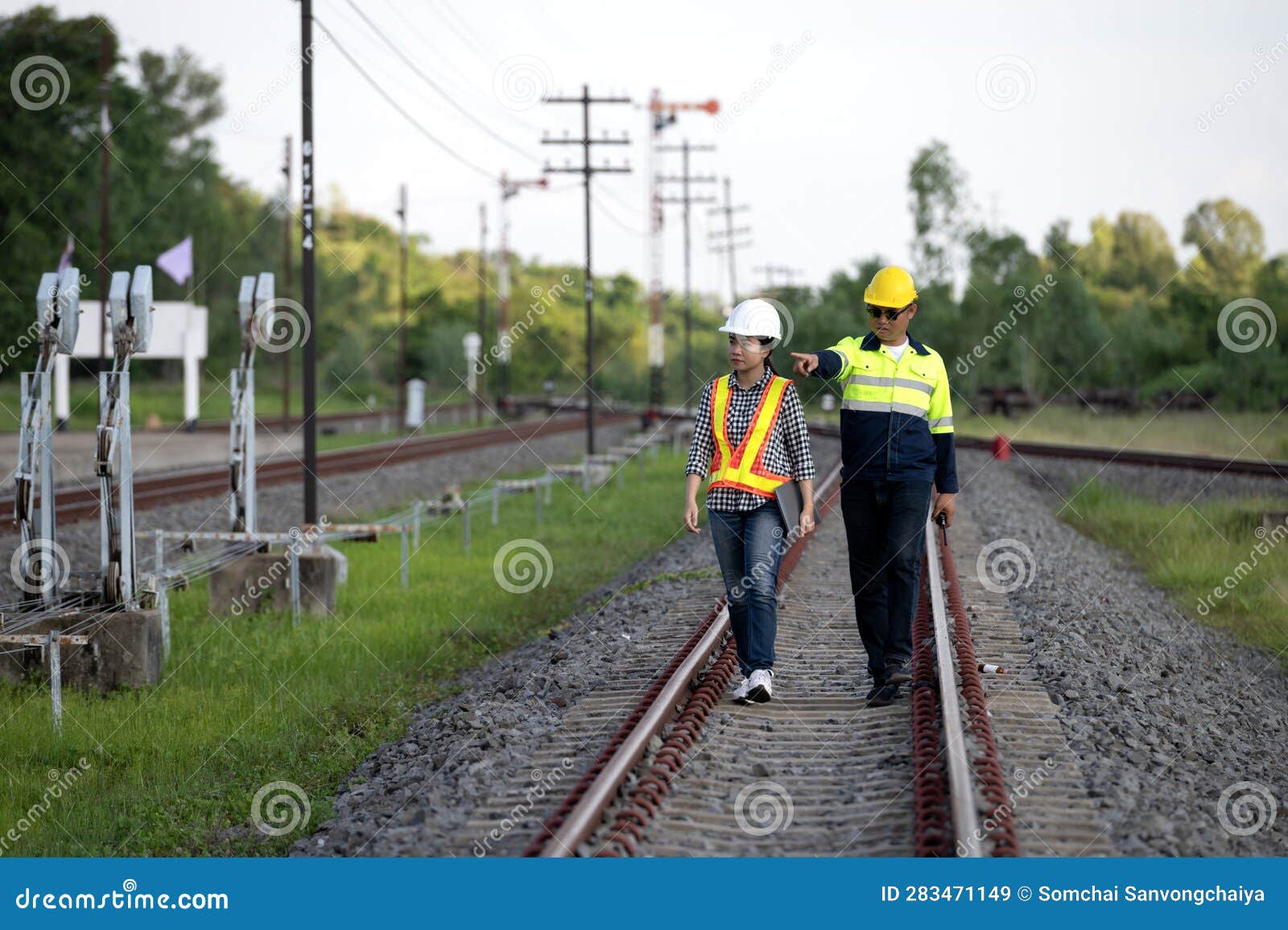 Asian Railway Engineer Inspects a Train Station Engineer Working on ...