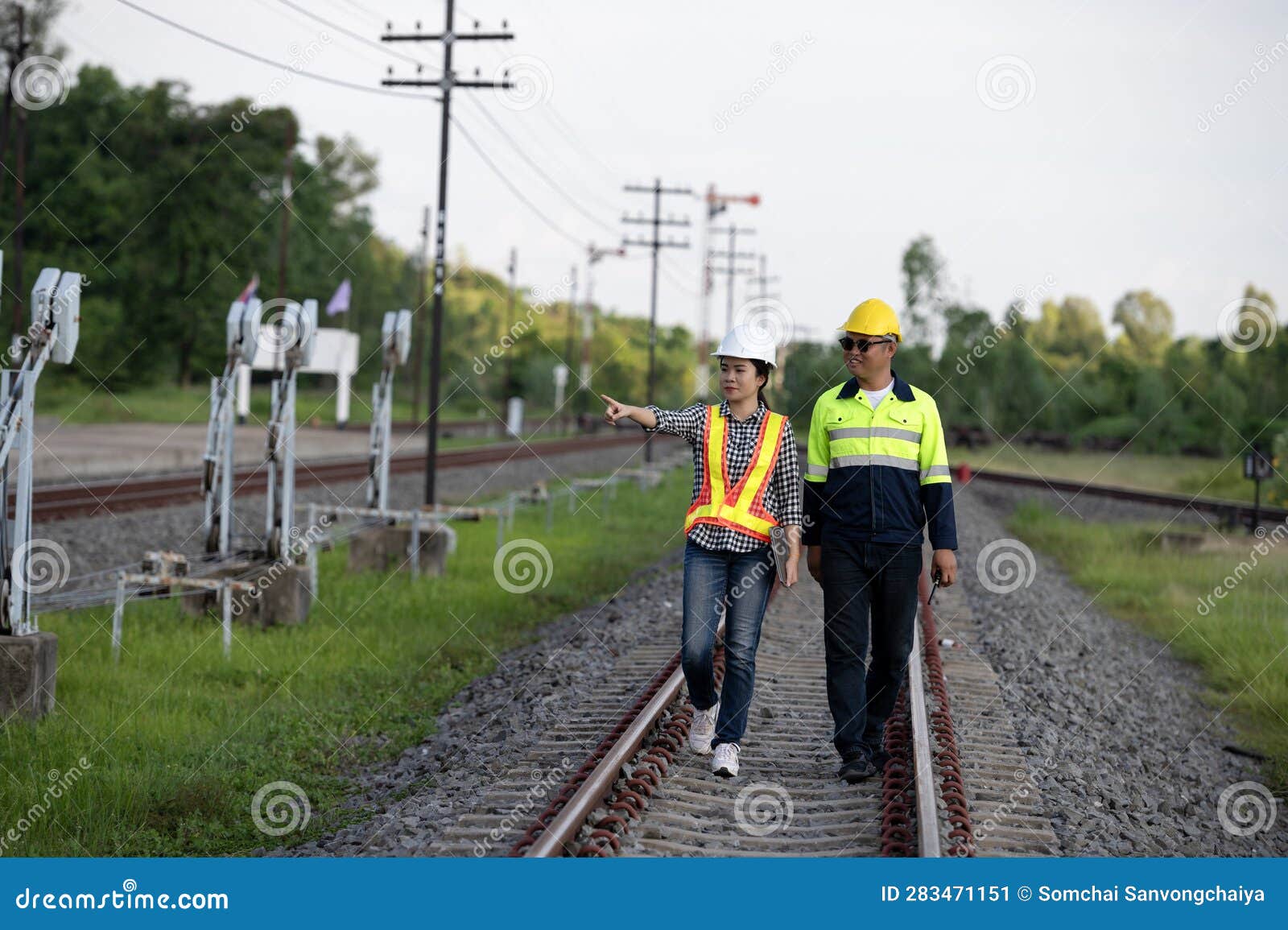 Asian Railway Engineer Inspects a Train Station Engineer Working on ...