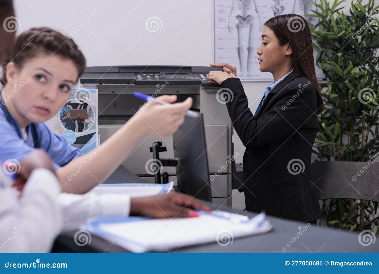 Asian Receptionist Putting Papers in Scanner Preparing Documents for ...