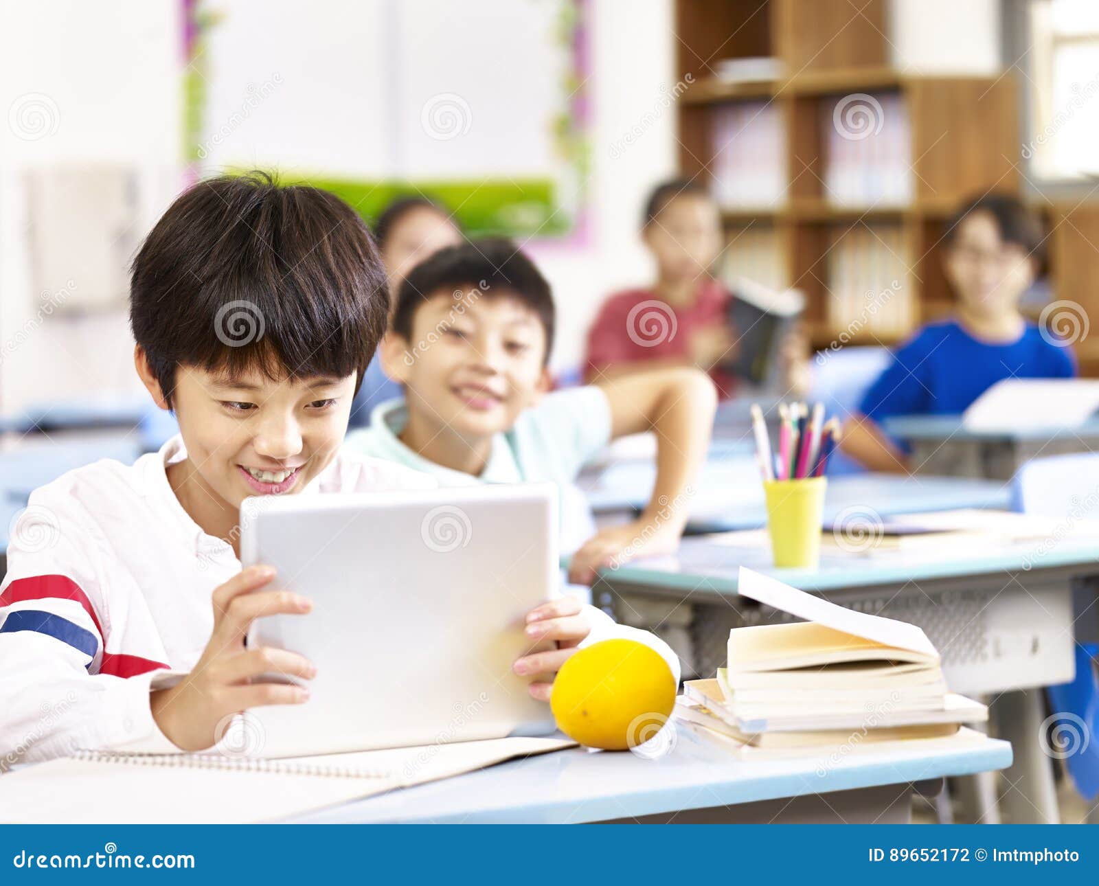 Asian Schoolboy Using Tablet in Classroom Stock Photo - Image of happy ...