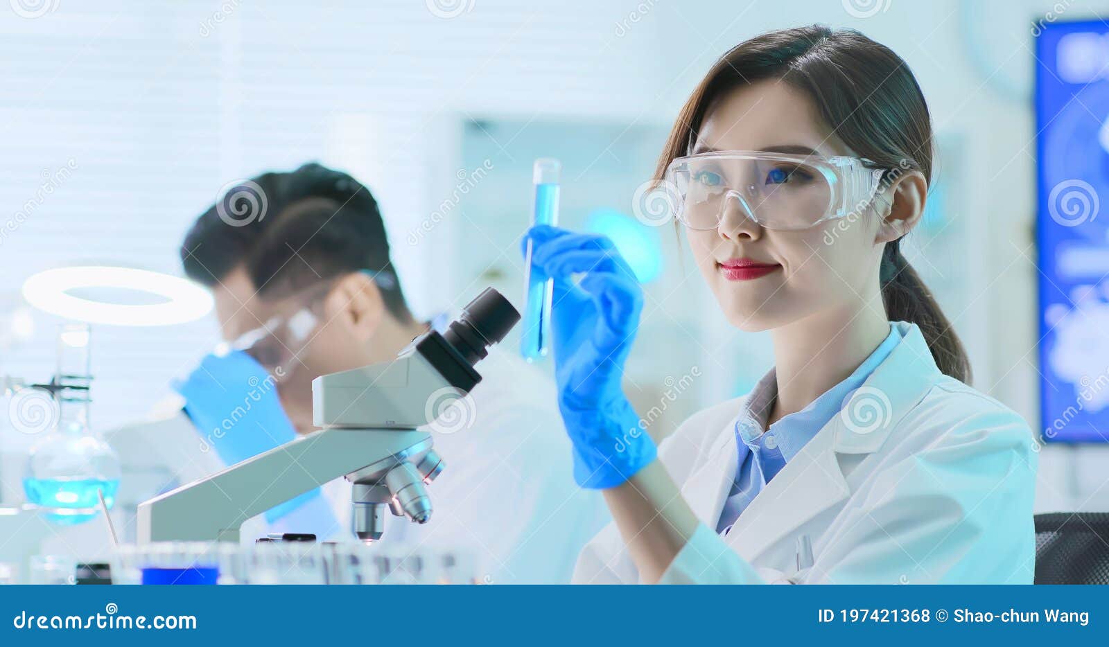 An Asian Scientist Or Chemist Looking At A Pill And Using Mechanical ...