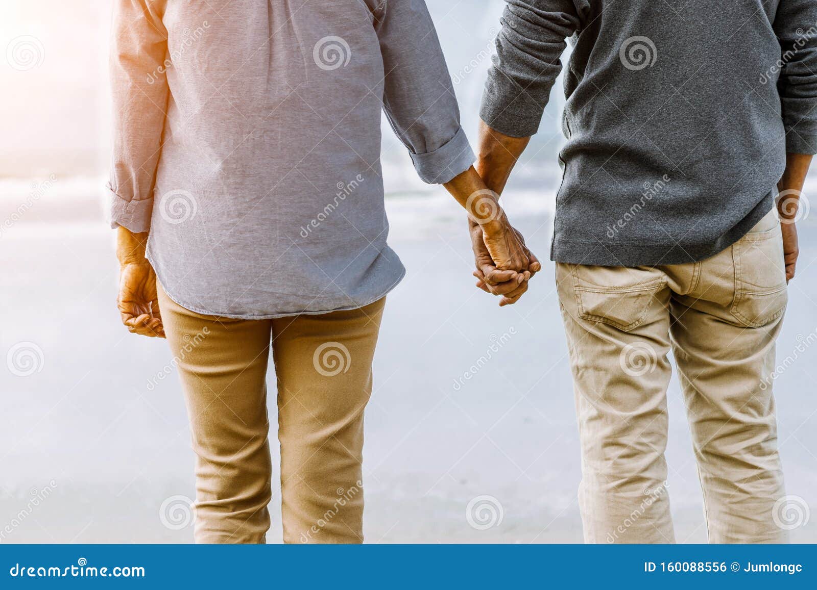 Asian Senior Couple Or Elderly People Walking And Siting At The Beach