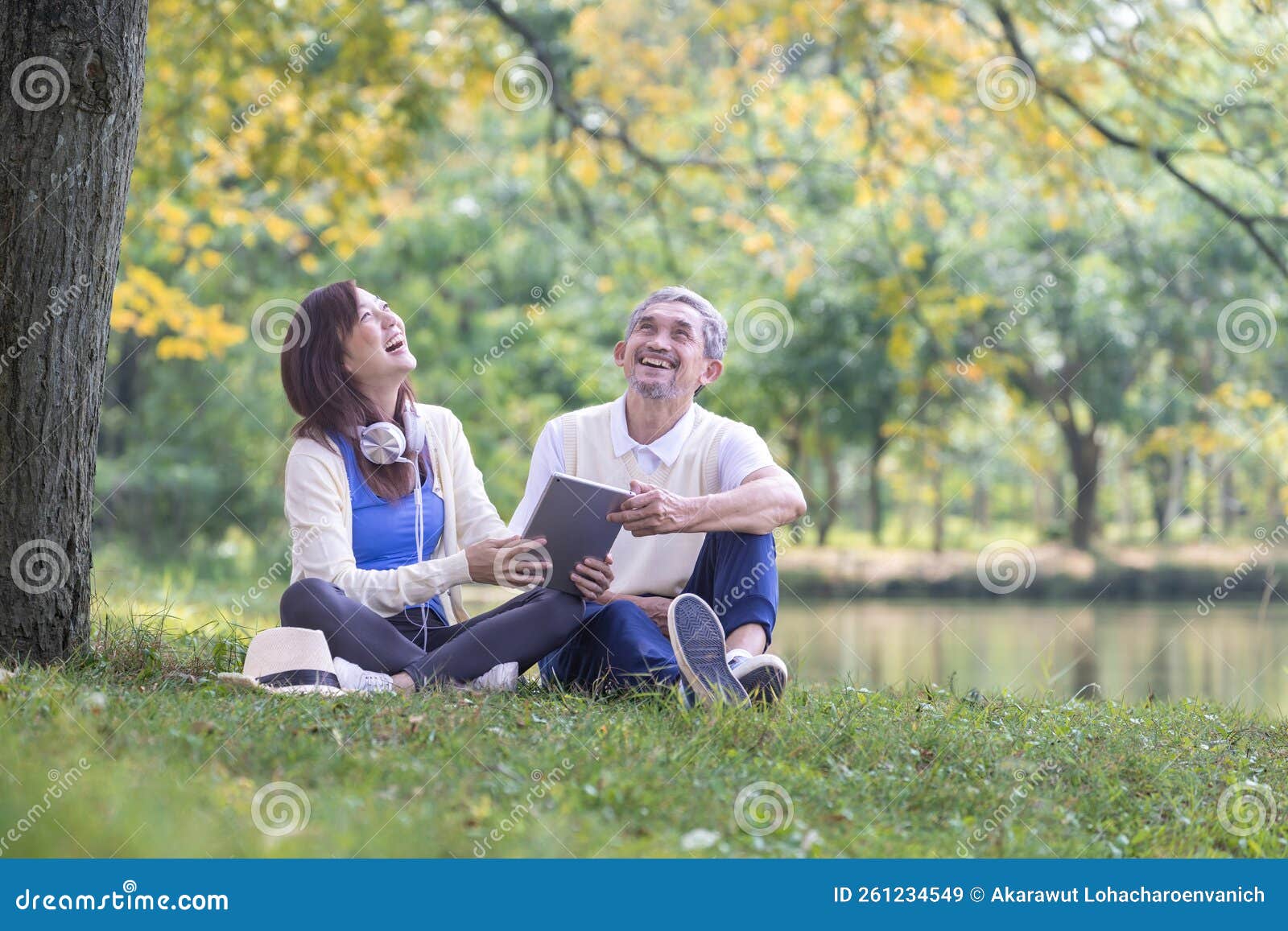 Asian Senior Father And Daughter Laughing While Happily Sitting