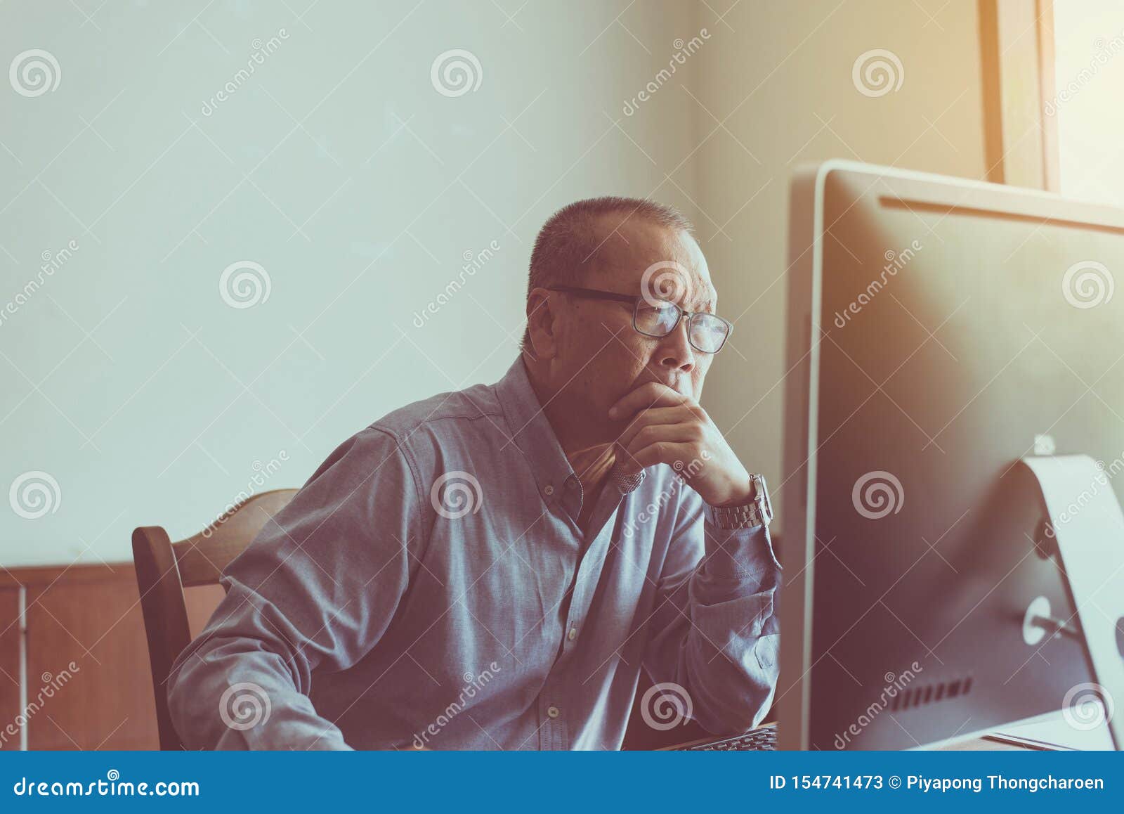 Asian Senior Man Serious Working and Using Computer at Home in the ...