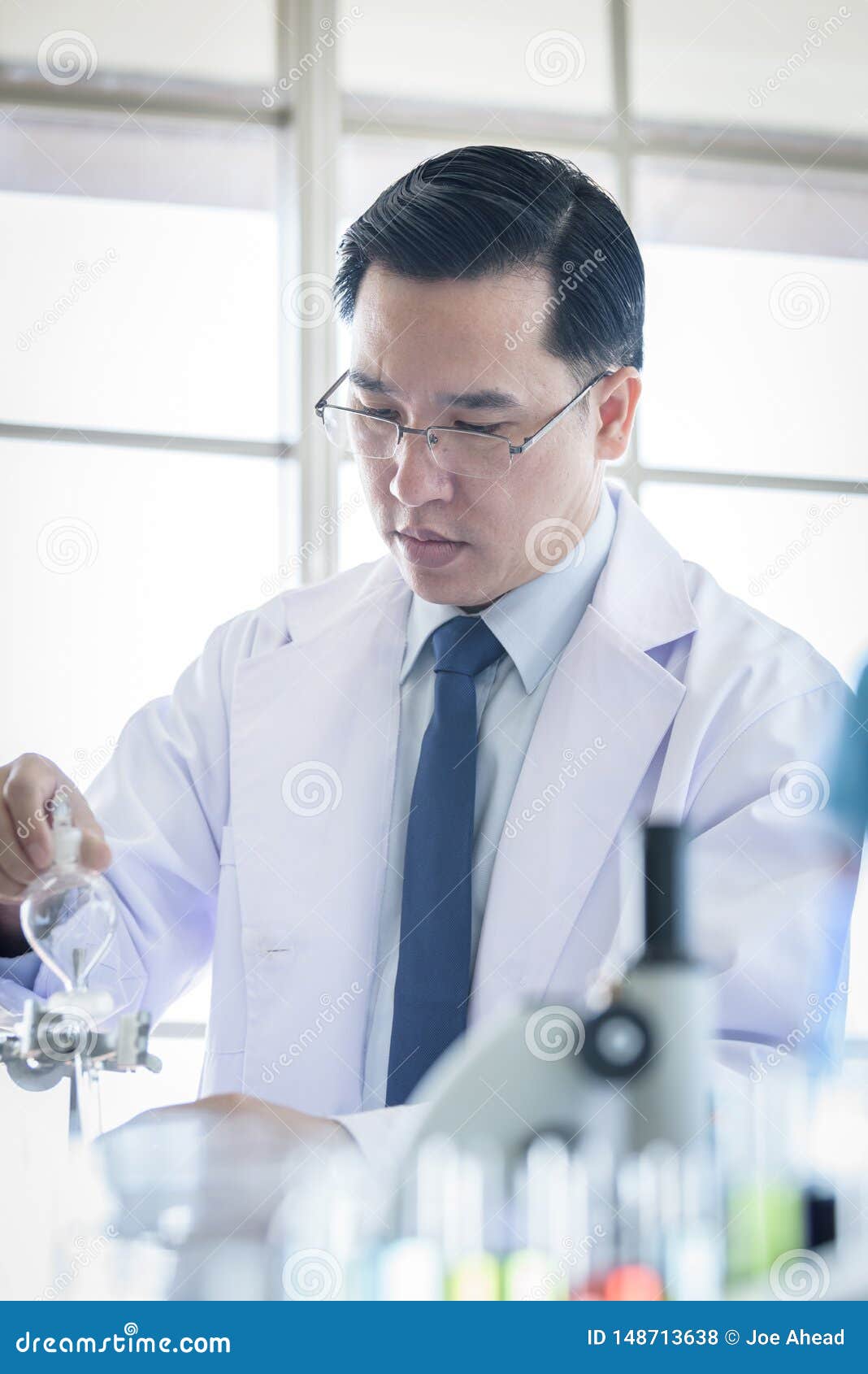 Asian Senior Scientist Researching and Learning in a Laboratory Stock ...