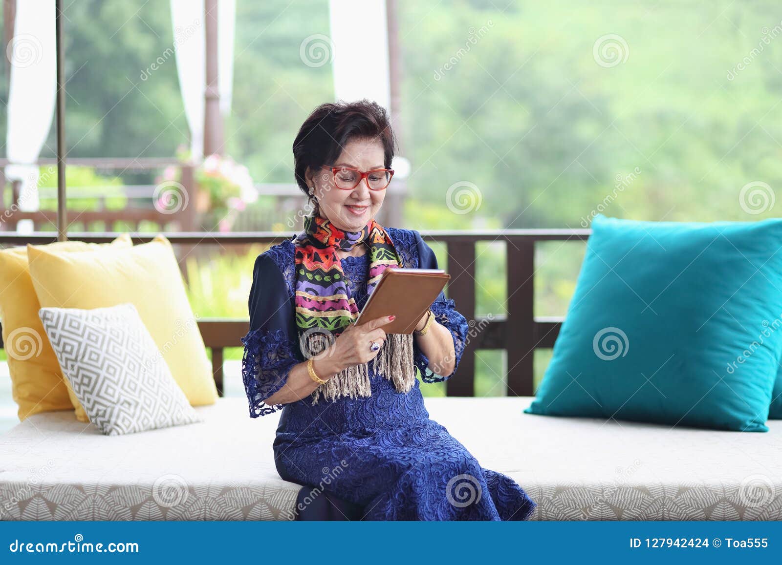 Asian Senior Woman Sitting and Using a Tablet Stock Photo - Image of ...
