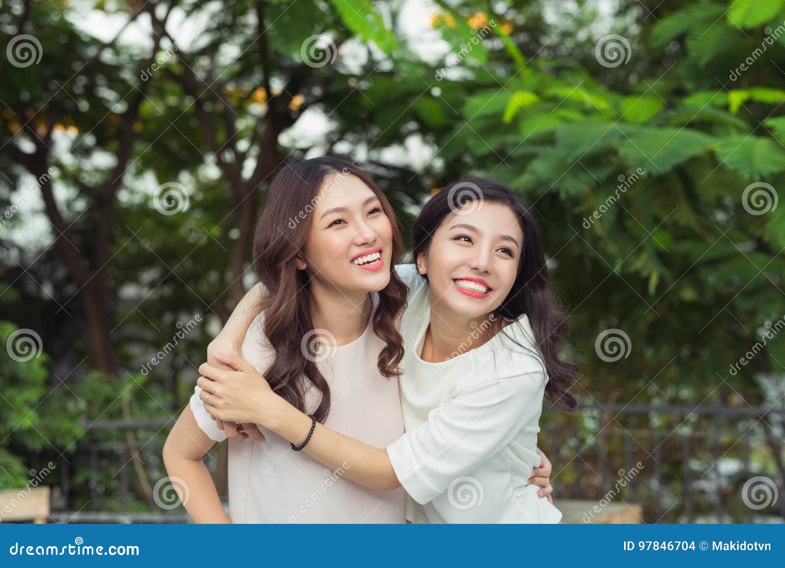 Asian Sisters Hugging and Smiling in the Park. Stock Photo - Image of ...