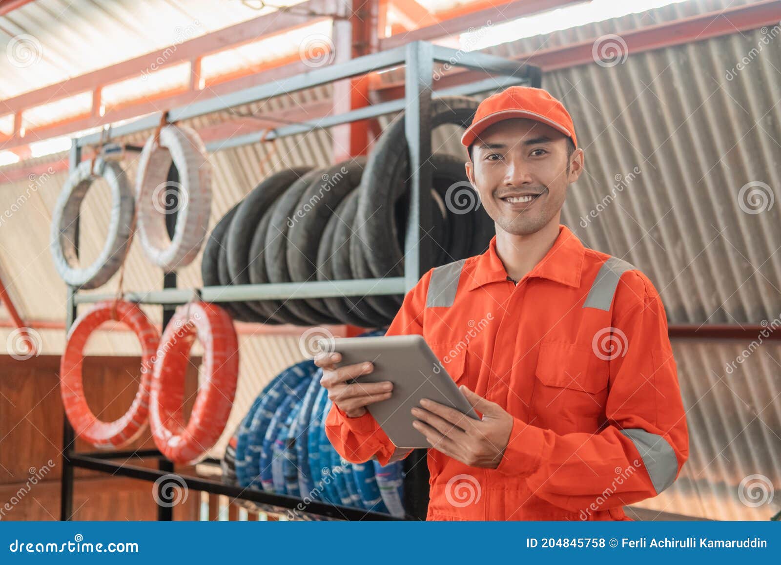 Mechanic In A Wearpack Uniform With Crossed Hands Stands Stock ...