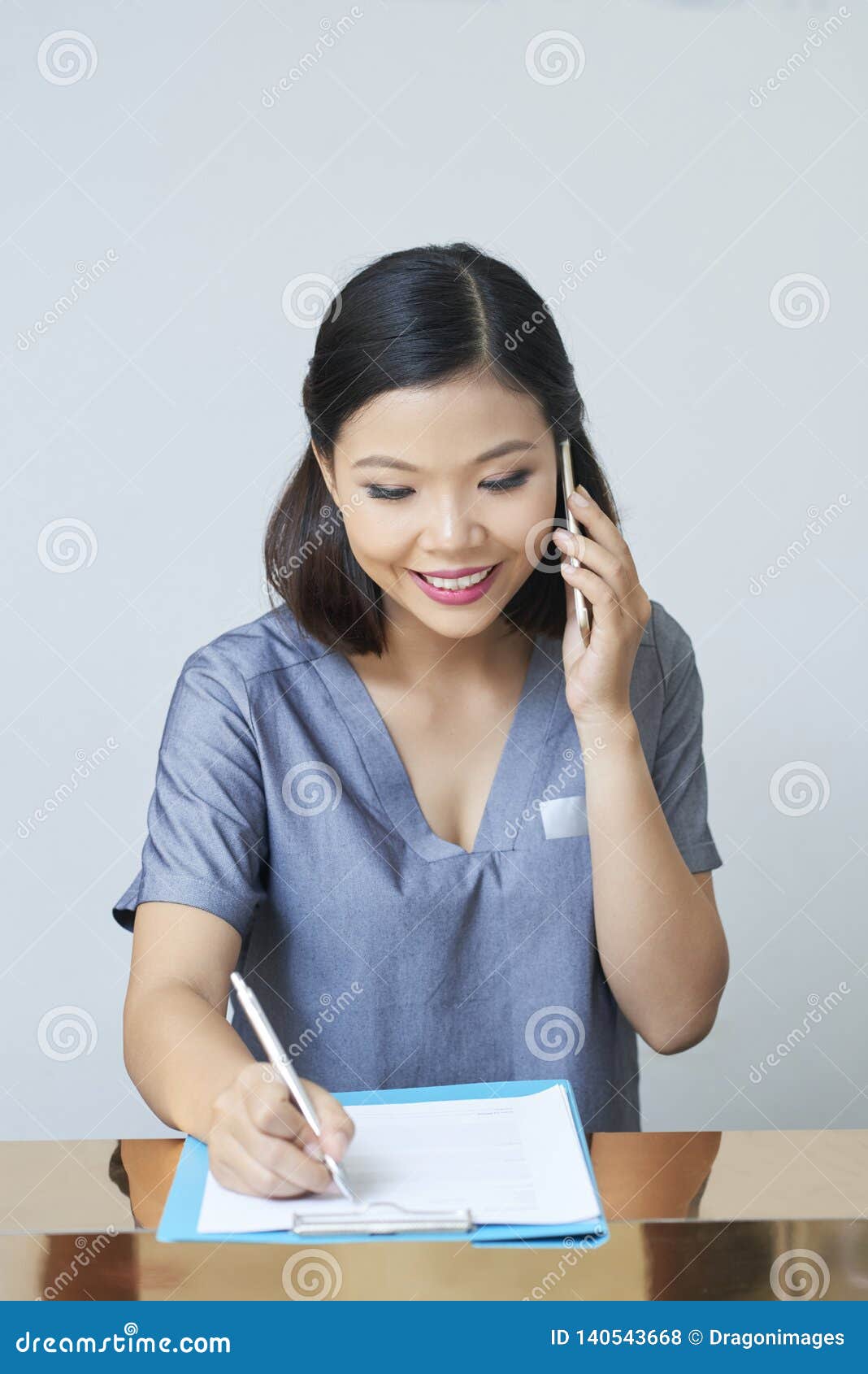 Spa worker receive calls stock photo. Image of clipboard - 140543668