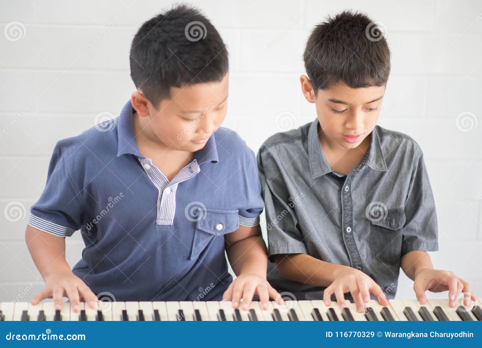 Asian Student Boys Playing Piano Together in Class Stock Image - Image ...