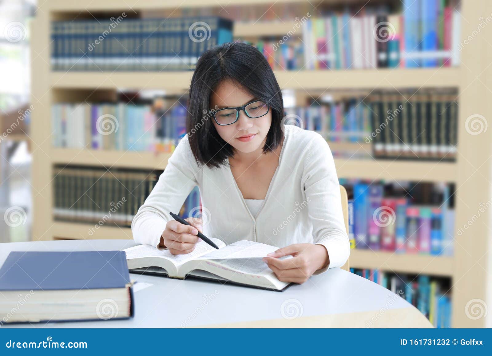 Asian Student Reading Book in the Library at University Stock Photo ...
