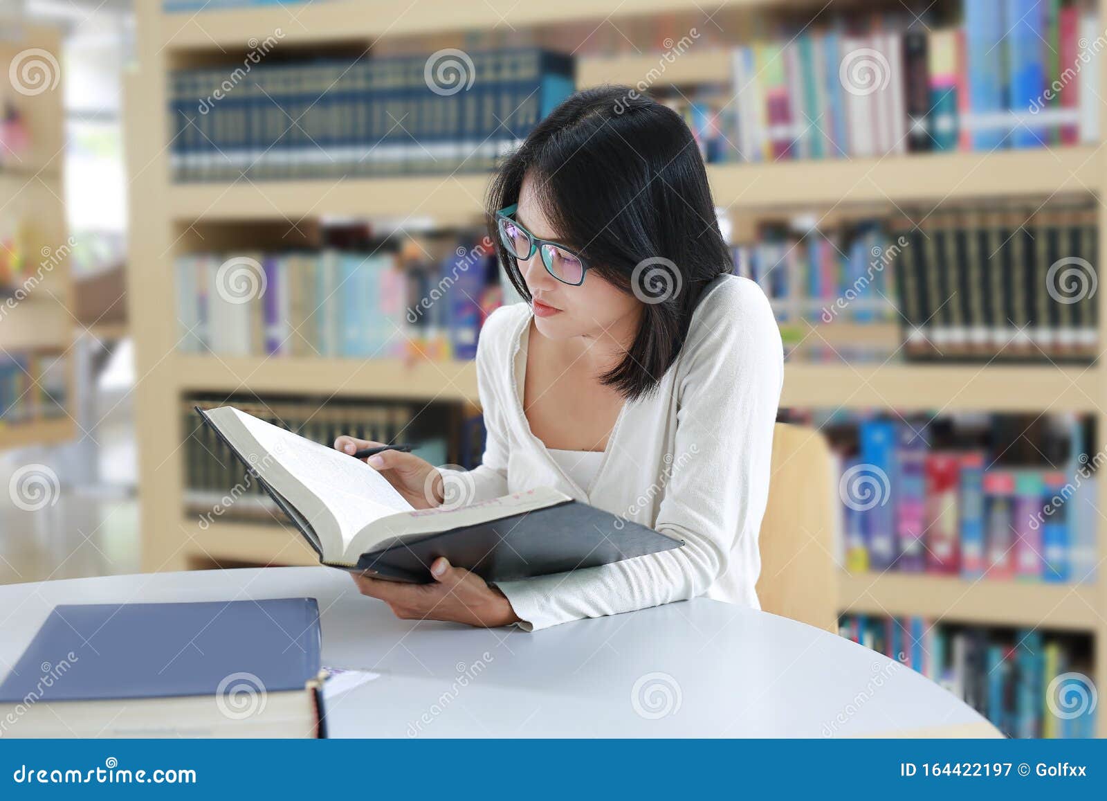 Asian Student Reading Book in the Library at University Stock Image ...