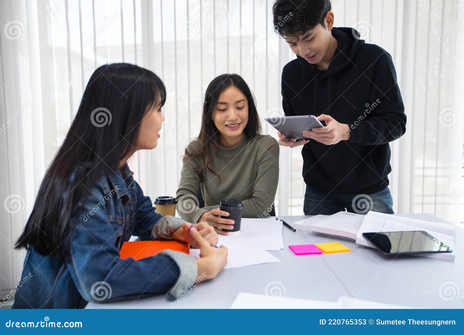 Asian Students Read Books and Use Digital Tablets To Find Information ...