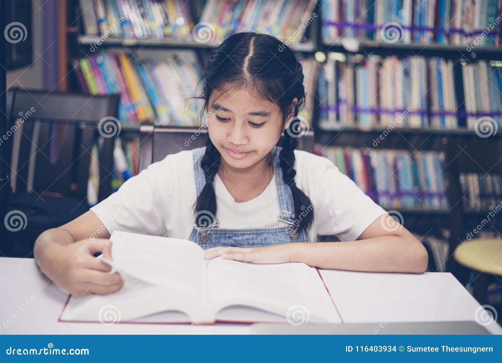Asian Students Reading Books in the Library. Stock Photo - Image of ...