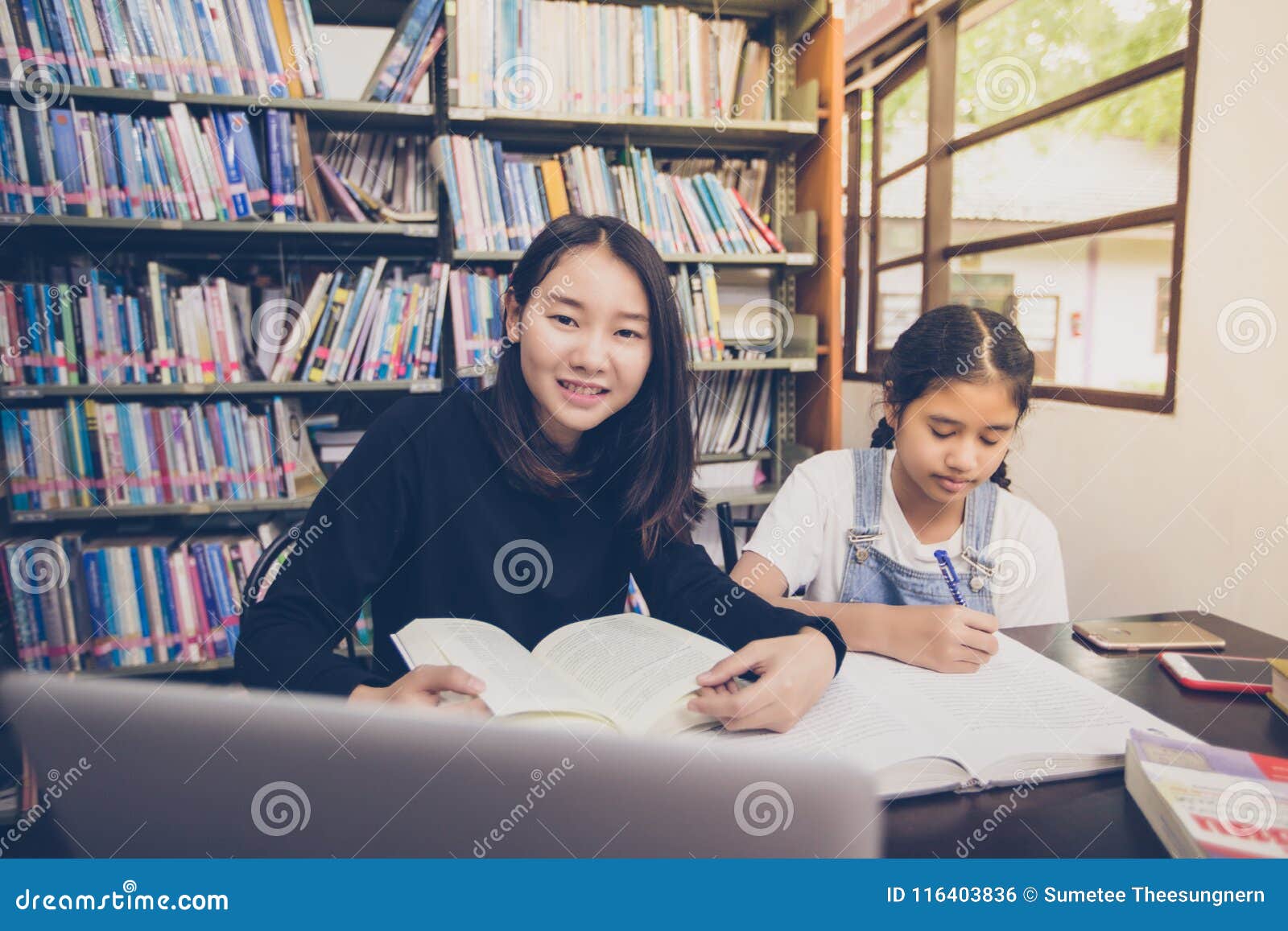 Asian Students Reading Books in the Library. Stock Photo - Image of ...