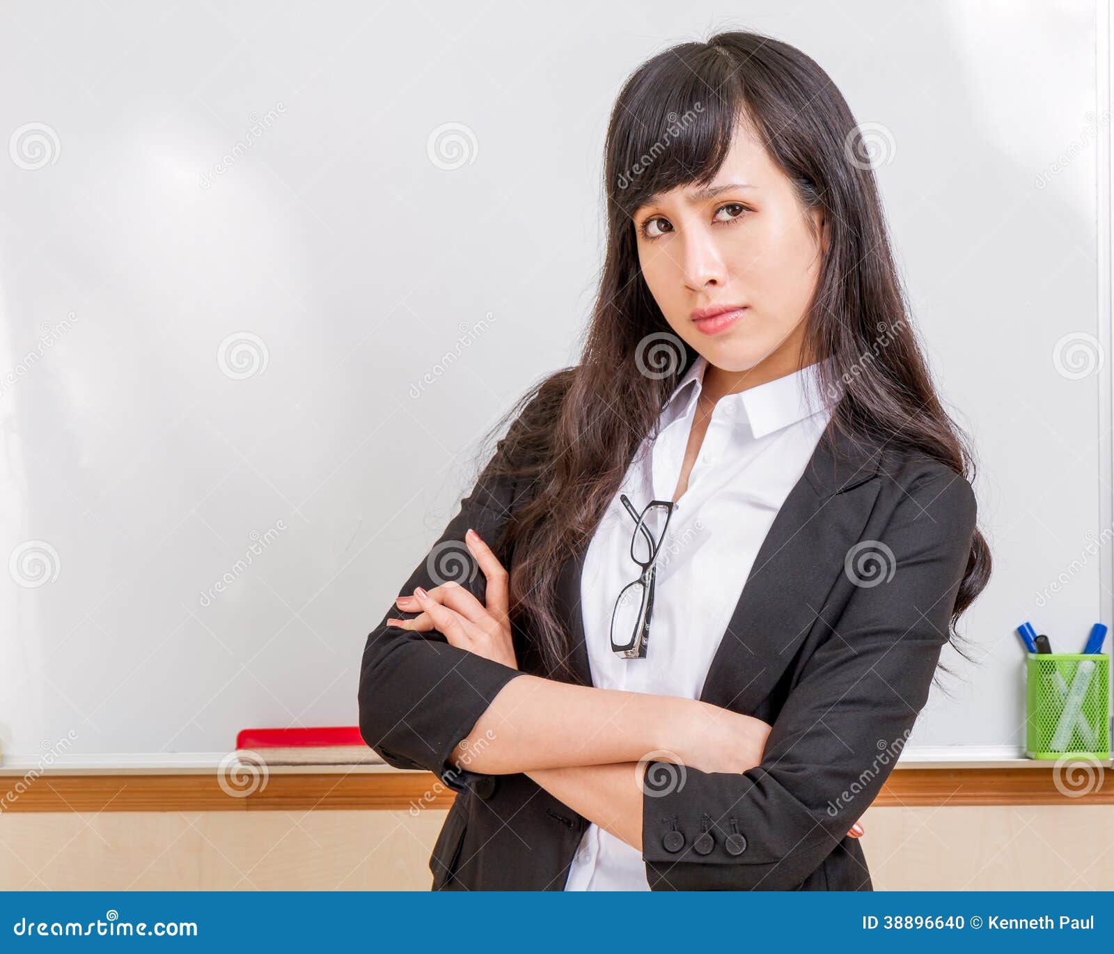 Asian Teacher Frowning in Front of Whiteboard Stock Photo - Image of ...