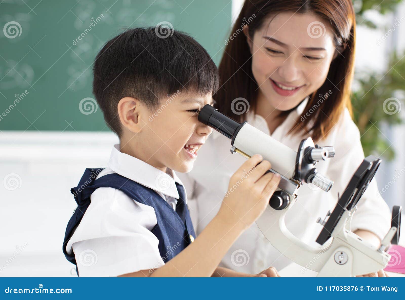 The Teacher Helps Schoolgirls In The Lesson, Prompting How To Solve The ... The Teacher Helps Schoolgirls In The Lesson, Prompting How To Solve The ...