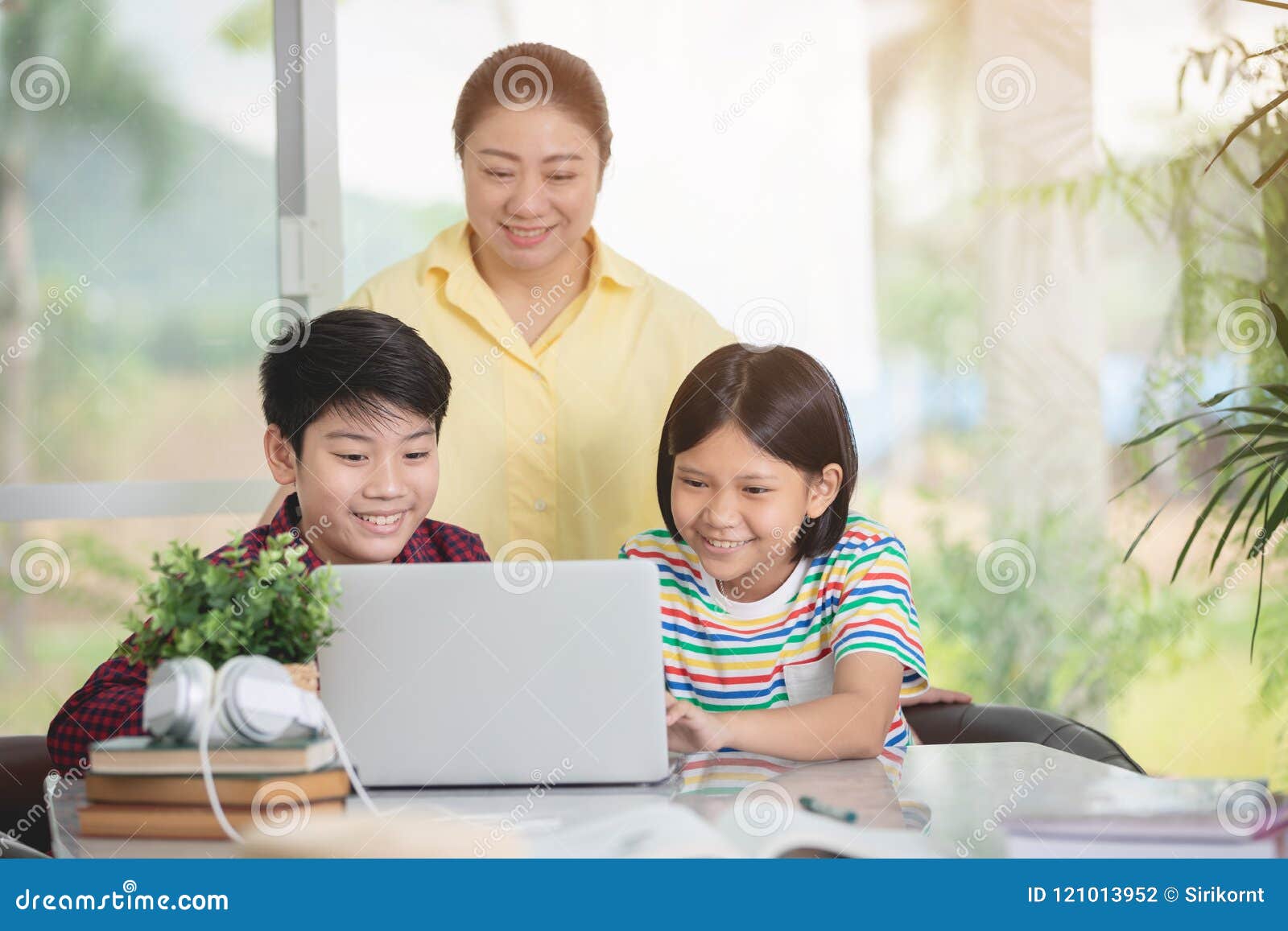 Asian Teacher and Kids Entertaining Using Laptop Computer. Stock Photo ...