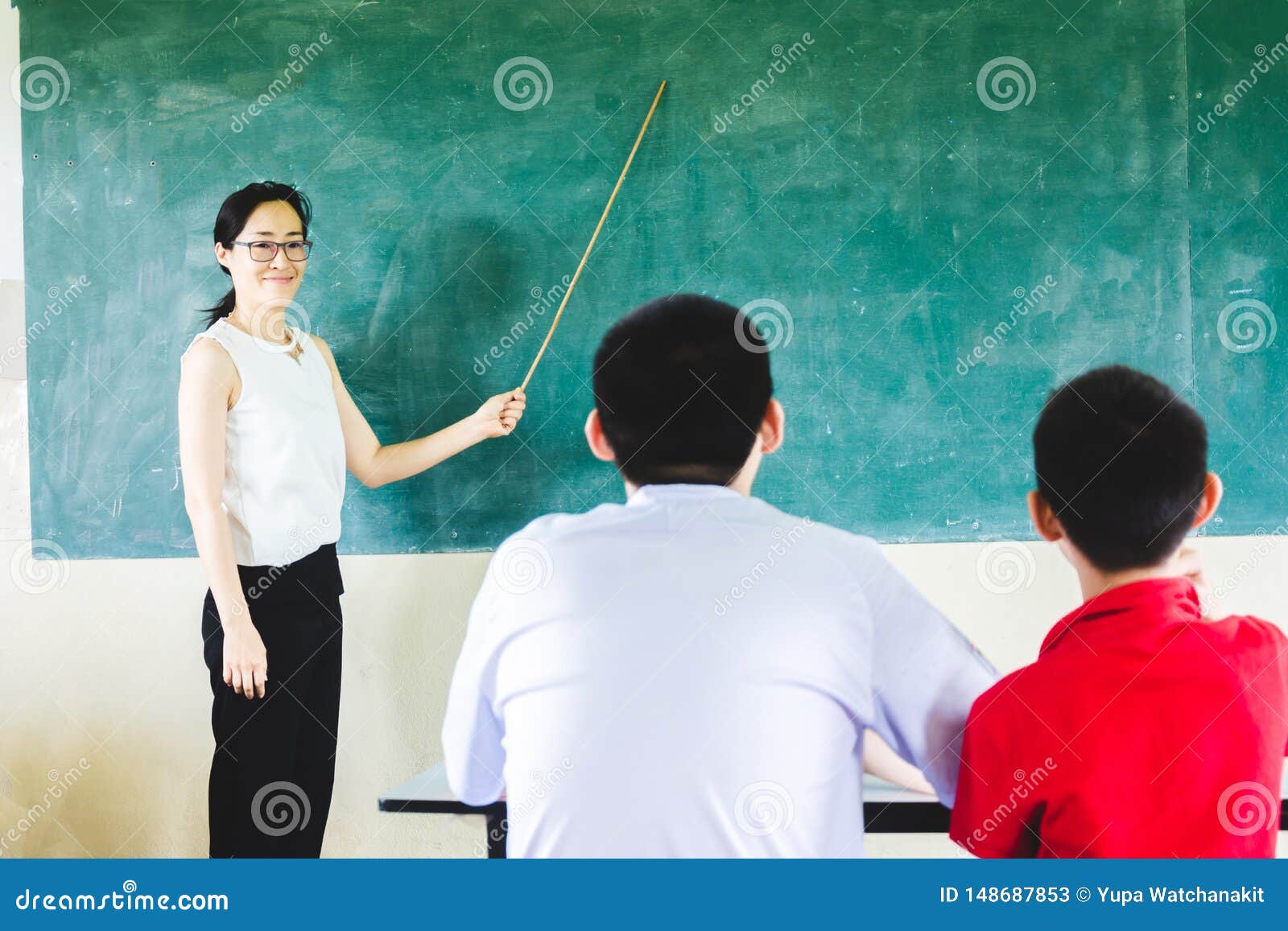 Teacher Teaching in Classroom with Chalkboard Background Stock Image ...