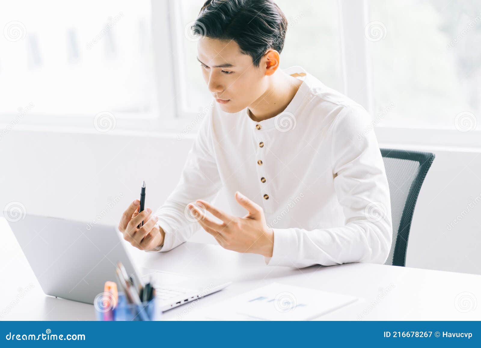 The Asian Team Leader is Working Remotely with the Staff Via Video Call ...