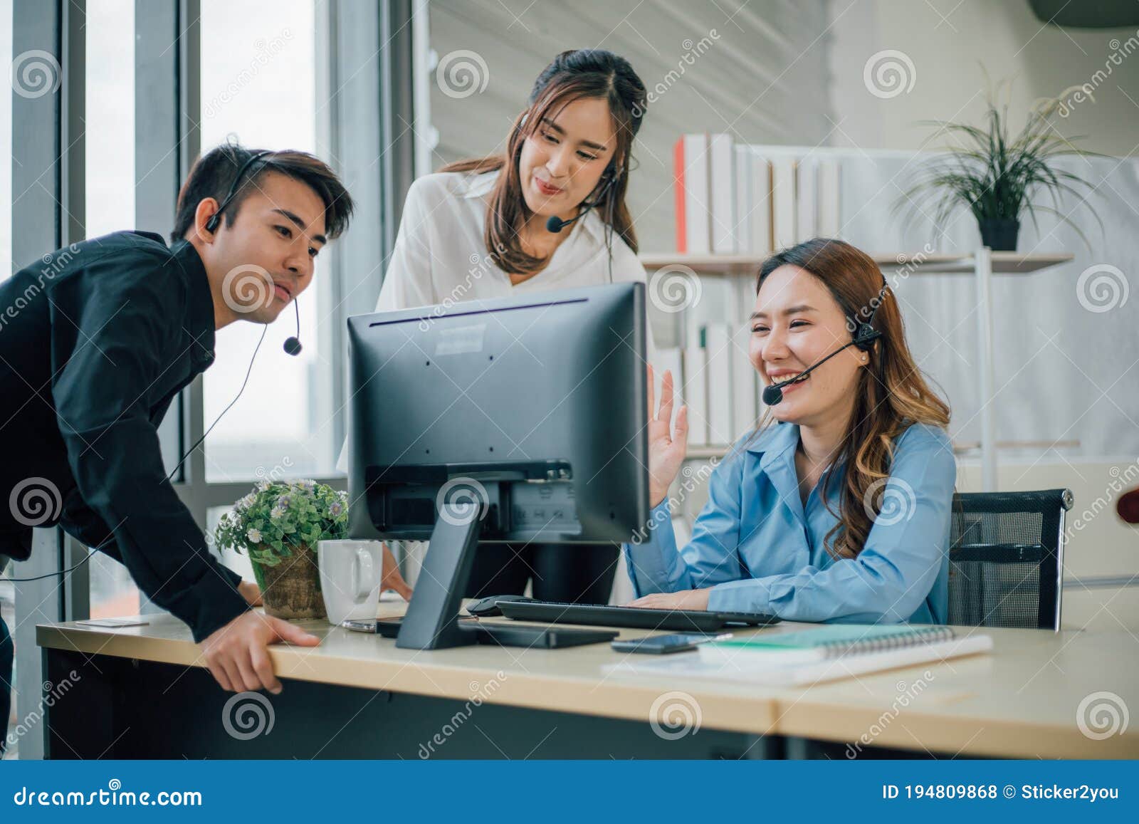Asian Team Worker in Headset Talking and Consulting with Online ...