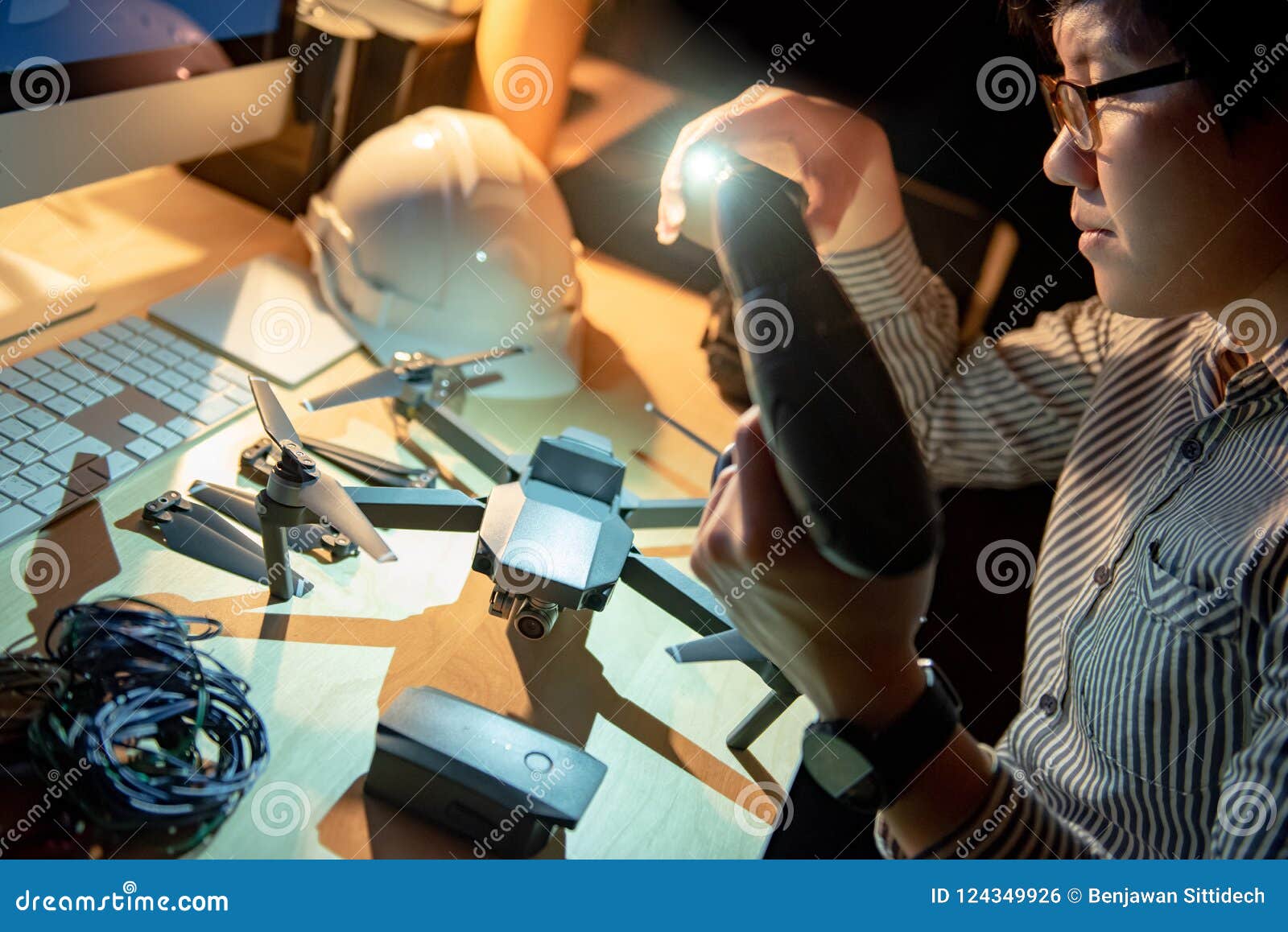 Asian Technical Engineer Using Electric Screwdriver for Repairing Drone ...