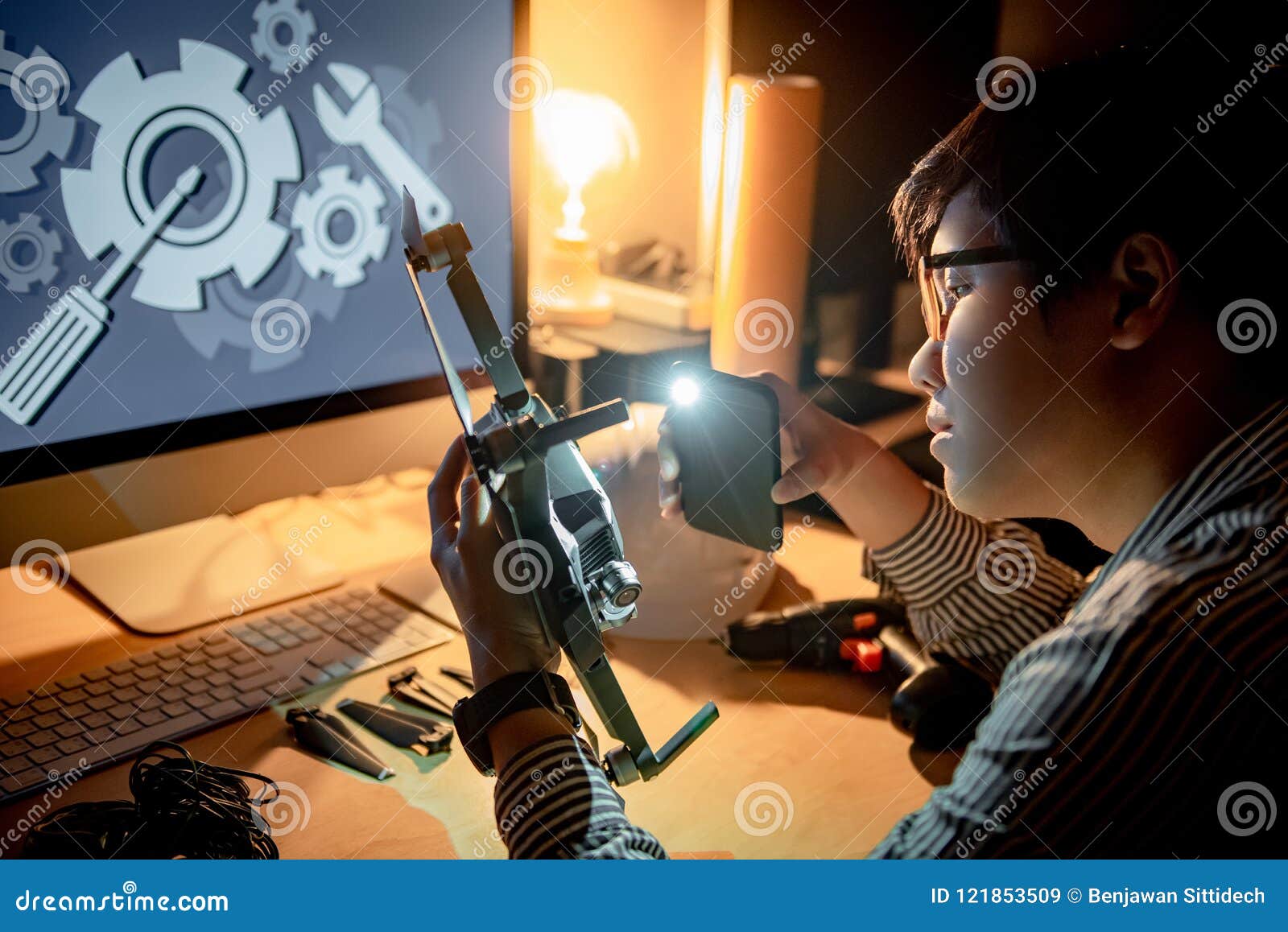 Asian Technical Engineer Using Flashlight from Smartphone for Checking ...