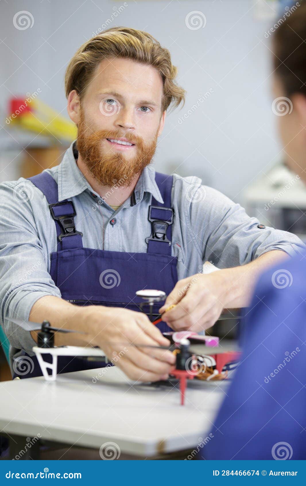 Asian Technical Engineer Using Screwdriver for Repairing Drone Stock ...