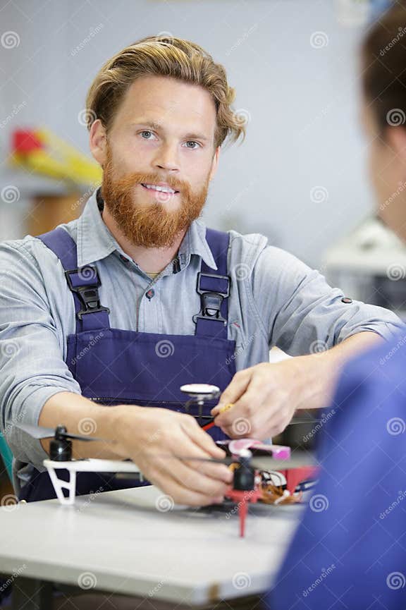 Asian Technical Engineer Using Screwdriver for Repairing Drone Stock ...