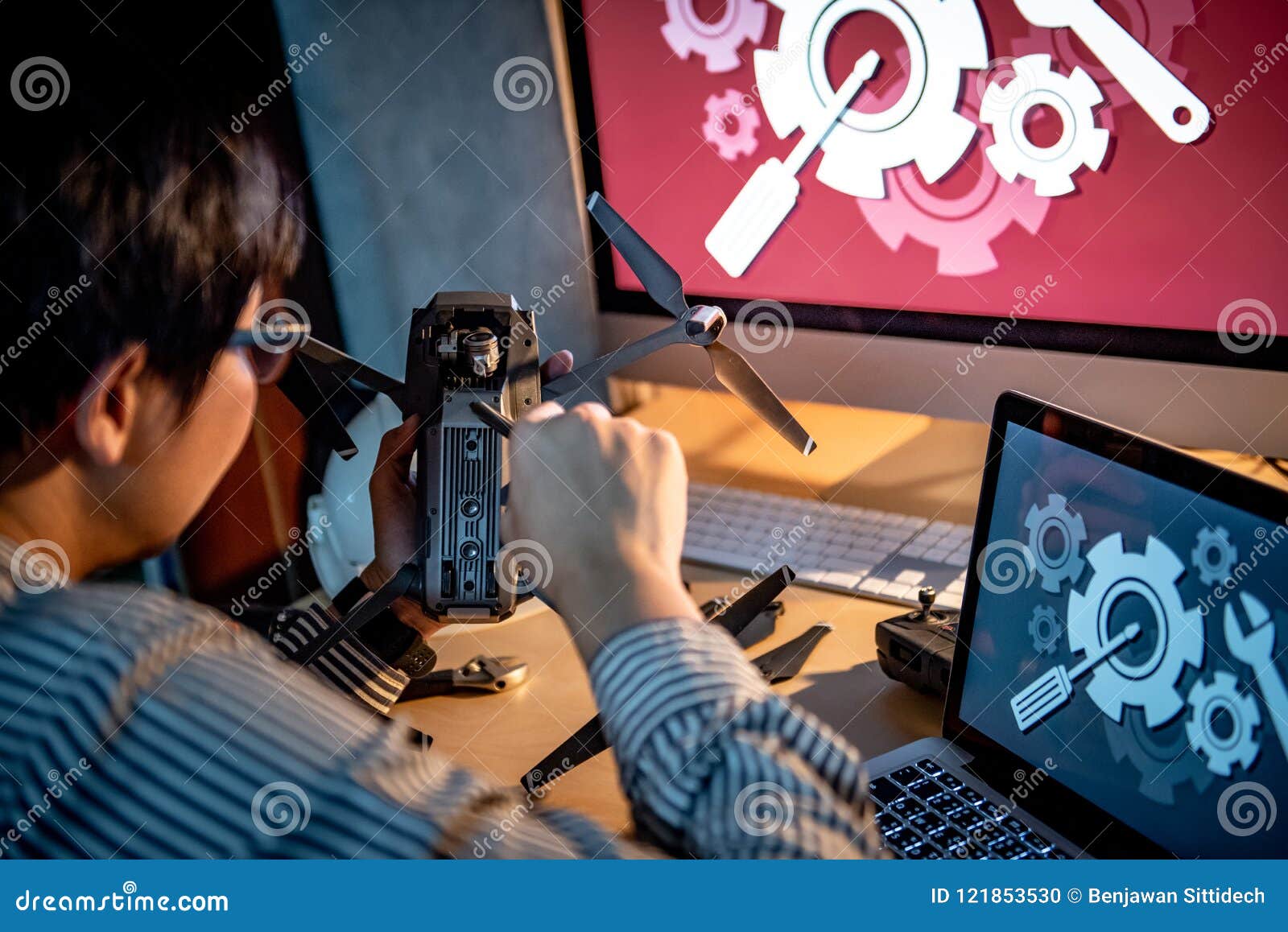 Asian Technical Engineer Using Screwdriver for Repairing Drone Stock ...