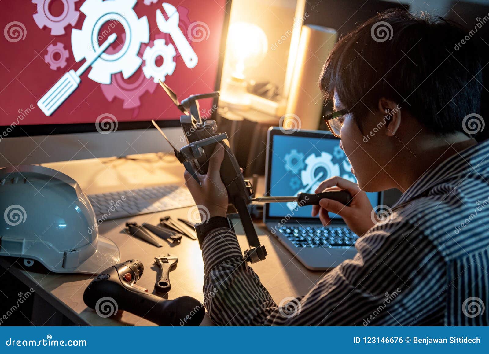 Asian Technical Engineer Using Screwdriver for Repairing Drone Stock ...