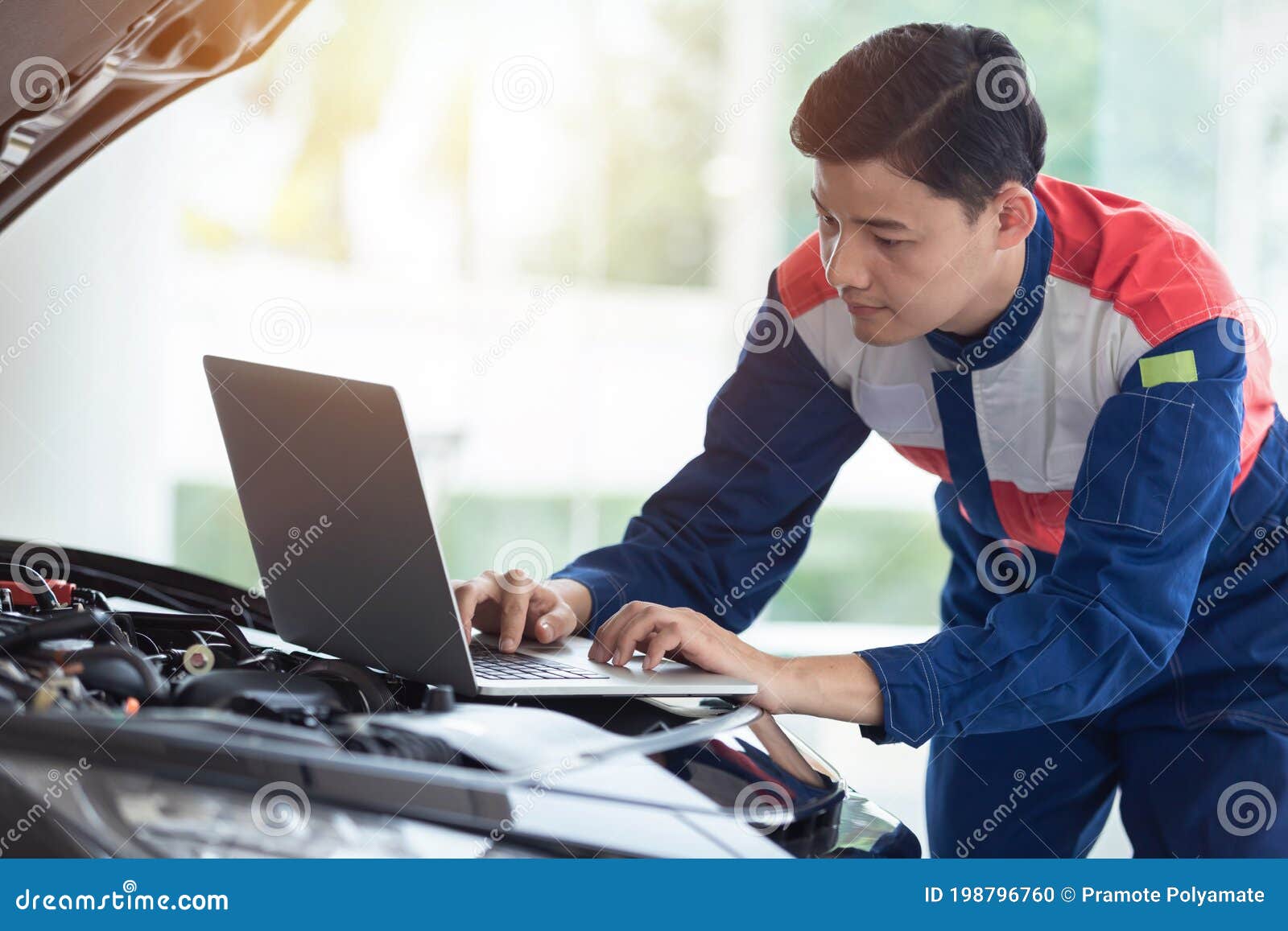 Asian Technician or Auto Mechanic Check Engine System. New Car with a ...