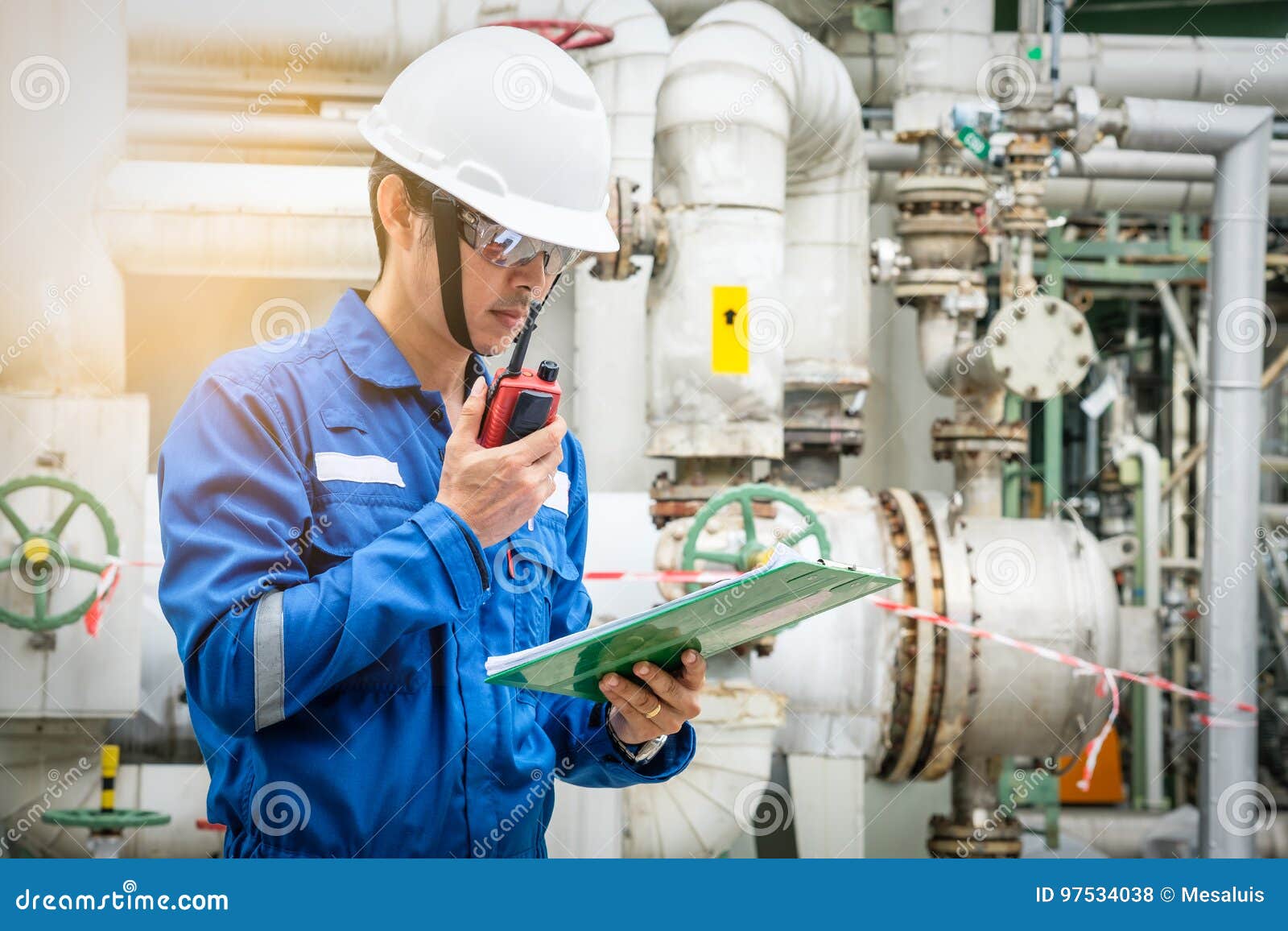 Asian Technician Working with the Walkie-talkie and Checklist Stock ...
