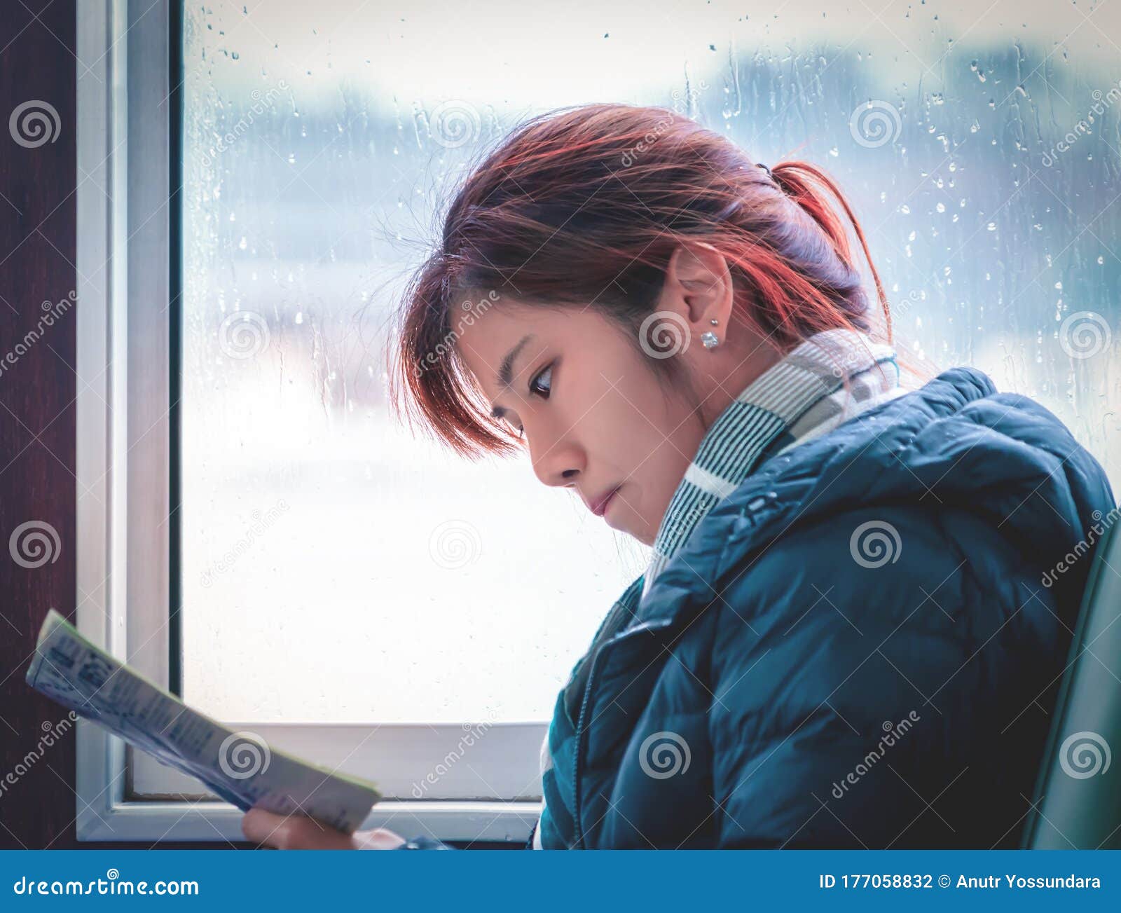 Tourist Sitting on a Train Reading Map and Tourist Information while ...