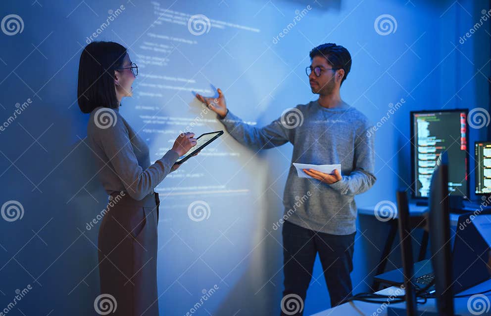 Asian Two Software Developers Presentation in Collaborative Coding Session, with Code Projected ...