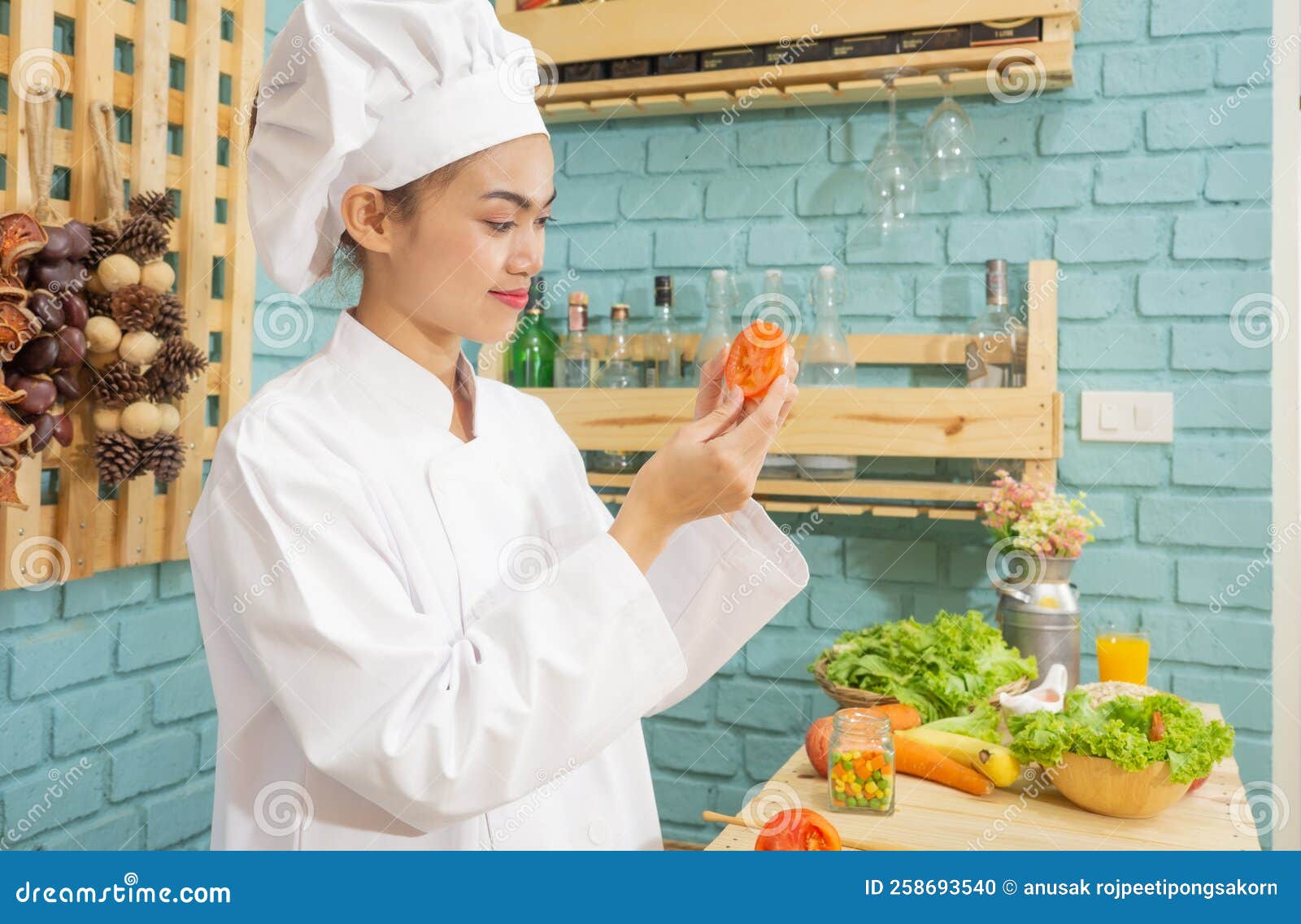 Asian Woman in Chef`s Uniform is Cooking in the Kitchen Stock Photo ...