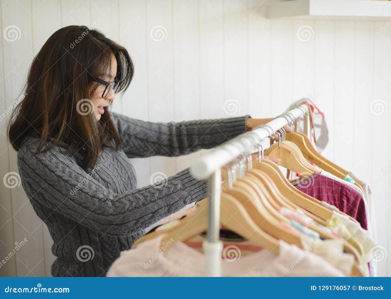 Asian Woman Choosing Clothes from Rack Stock Image - Image of clothes ...