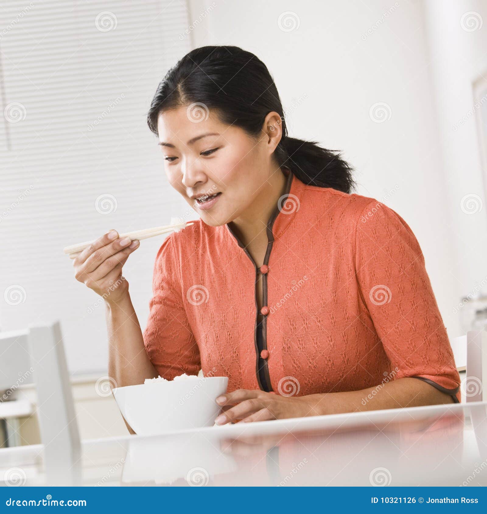 Asian woman eating rice. stock photo. Image of kitchen - 10321126