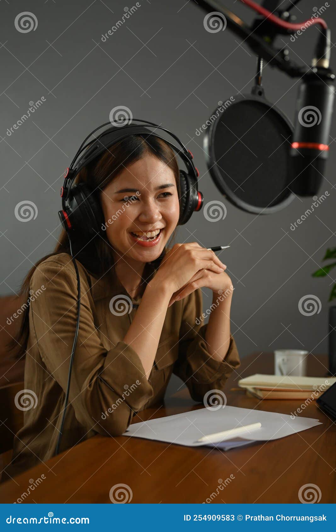 Asian Woman Podcaster Wearing Headphone Recording Podcast From Home