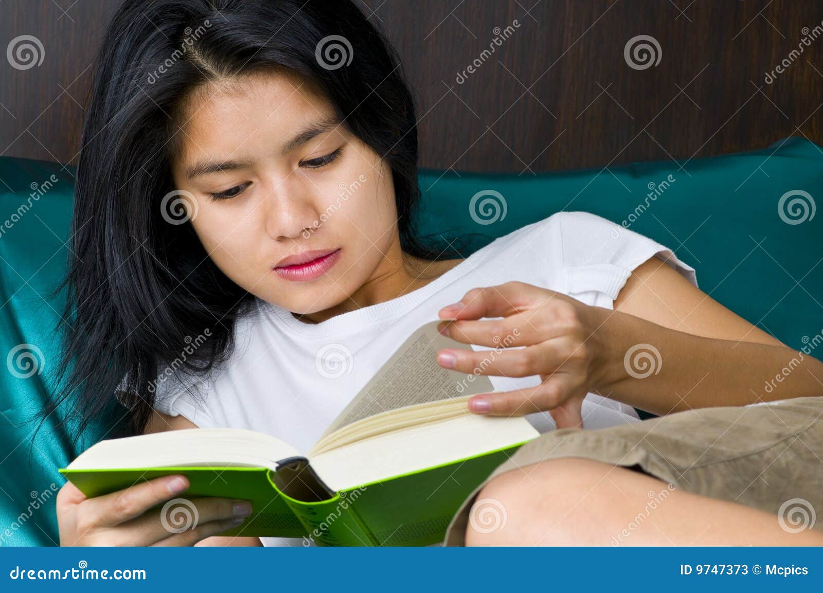 Asian woman reading a book stock image. Image of lying - 9747373
