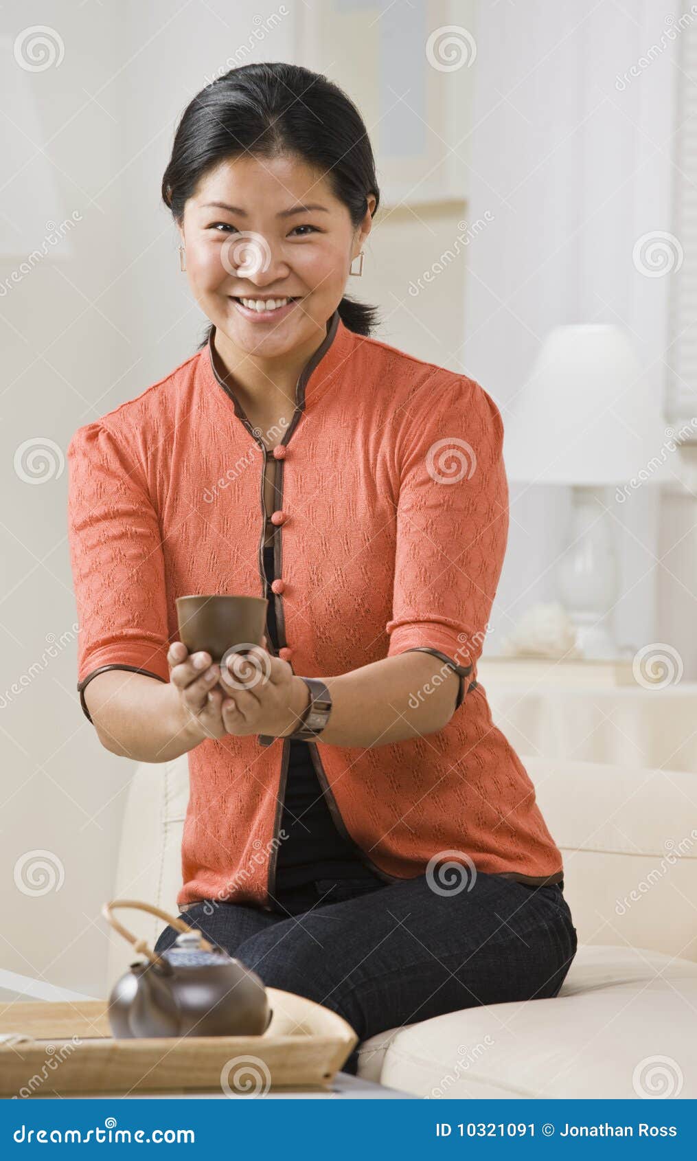 Asian woman serving tea. stock image. Image of female - 10321091